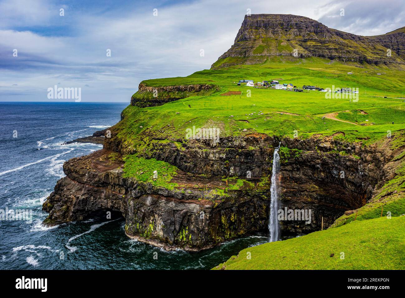 Gasadalur waterfall into the ocean, Vagar, Faroe islands, Denmark Stock ...