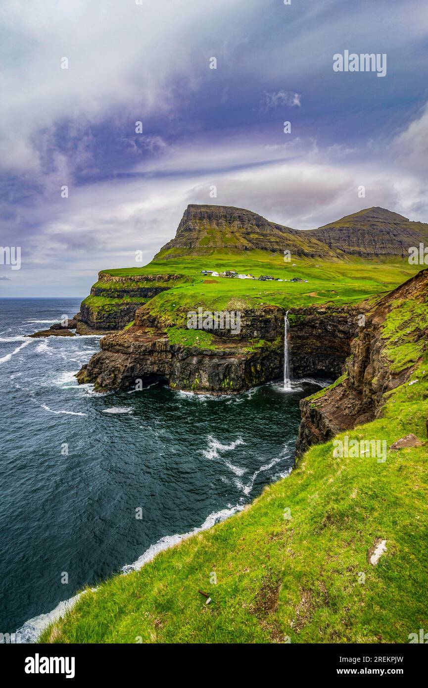 Gasadalur waterfall into the ocean, Vagar, Faroe islands, Denmark Stock ...