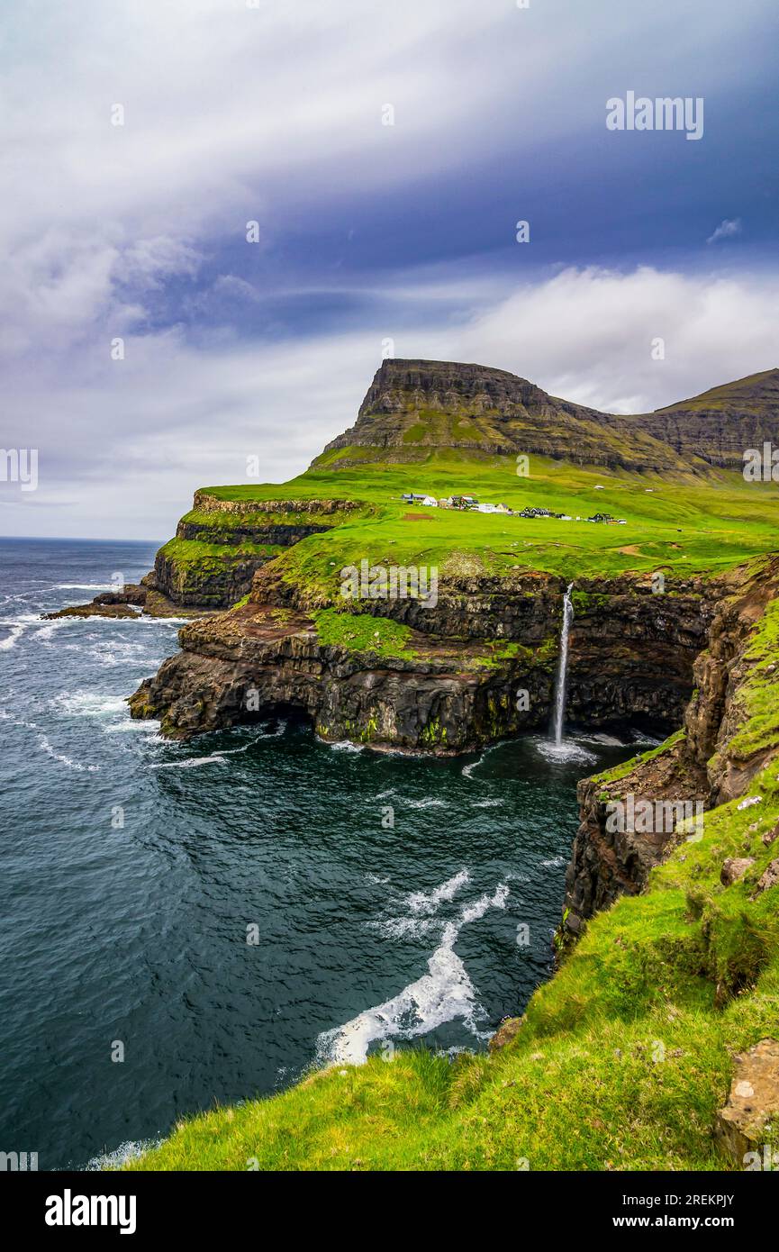 Gasadalur waterfall into the ocean, Vagar, Faroe islands, Denmark Stock ...
