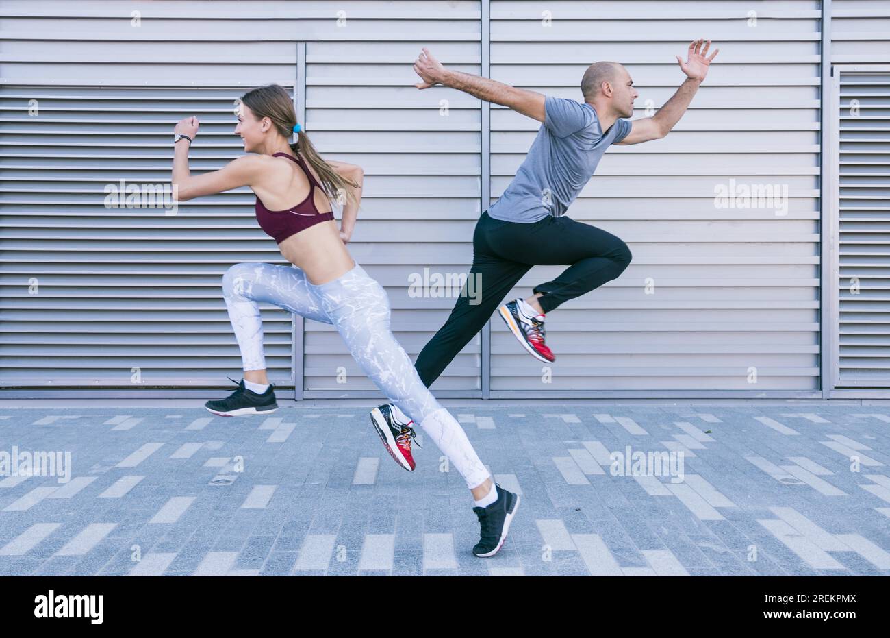 Active sportive young male female athlete running jumping air ...