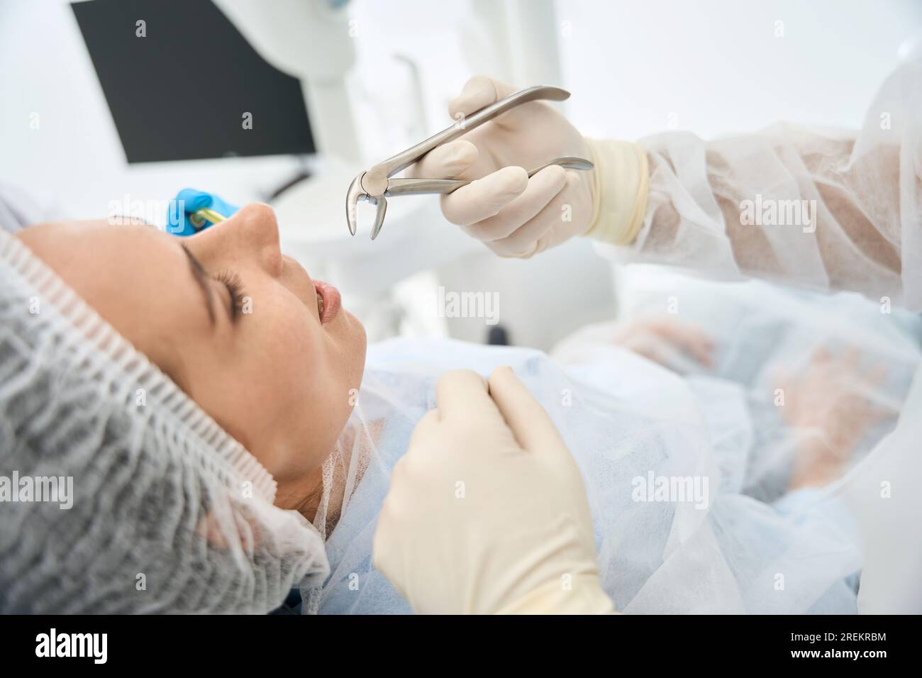 Young female patient in a dental chair on tooth extraction Stock Photo ...