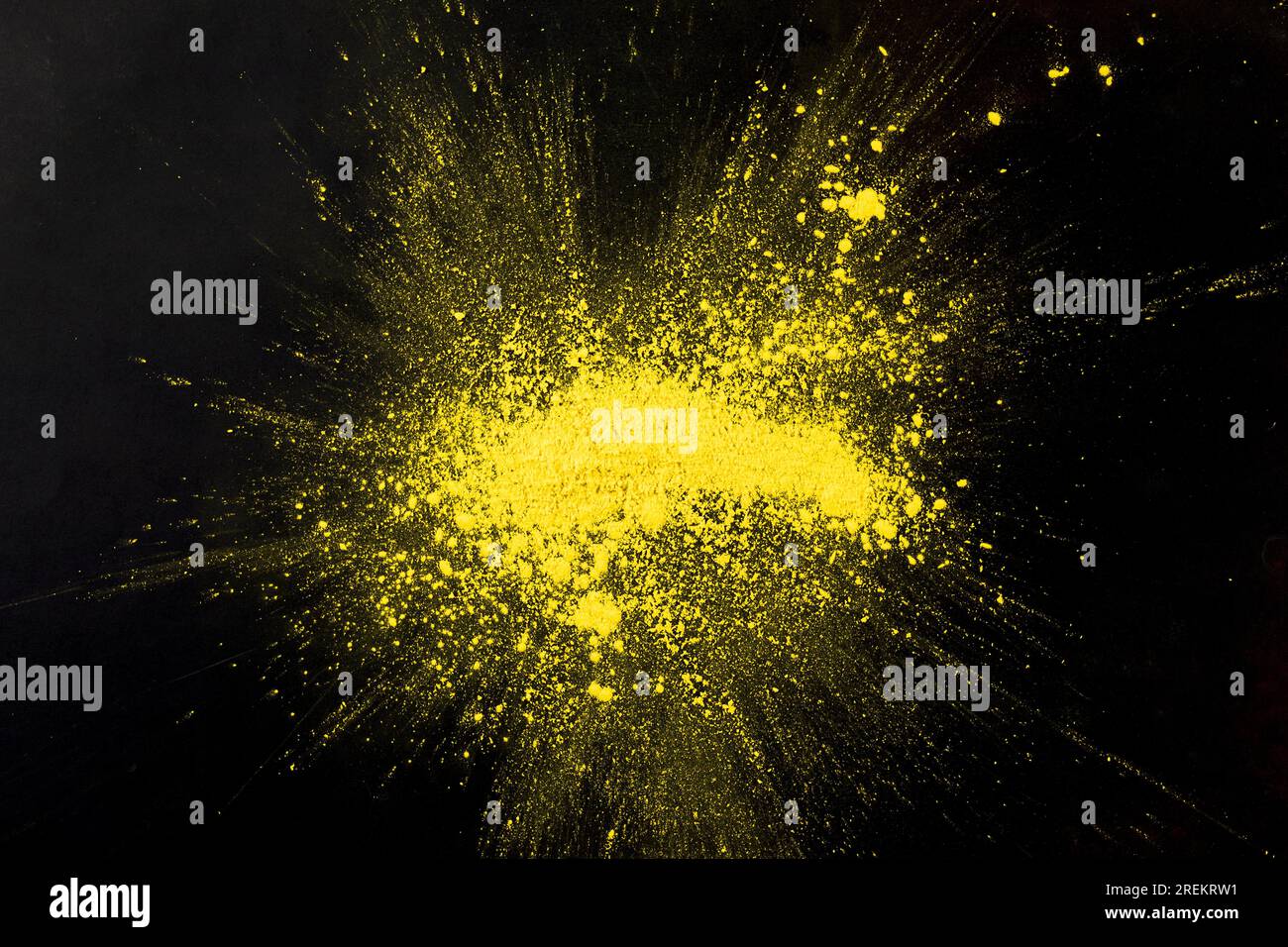 Explosion yellow colored powder black surface. Resolution and high ...