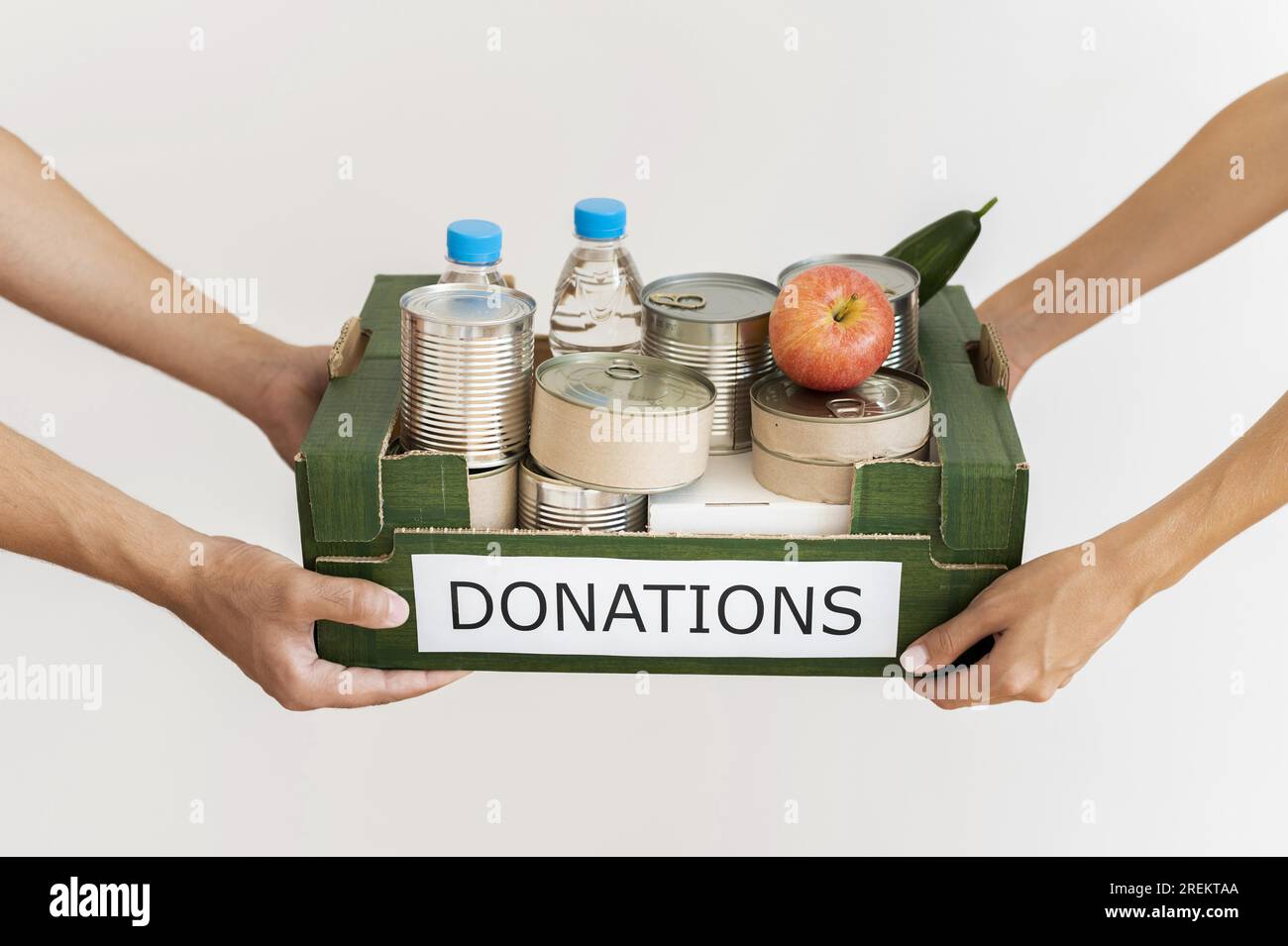 Hands holding donation box with provisions. Resolution and high quality ...