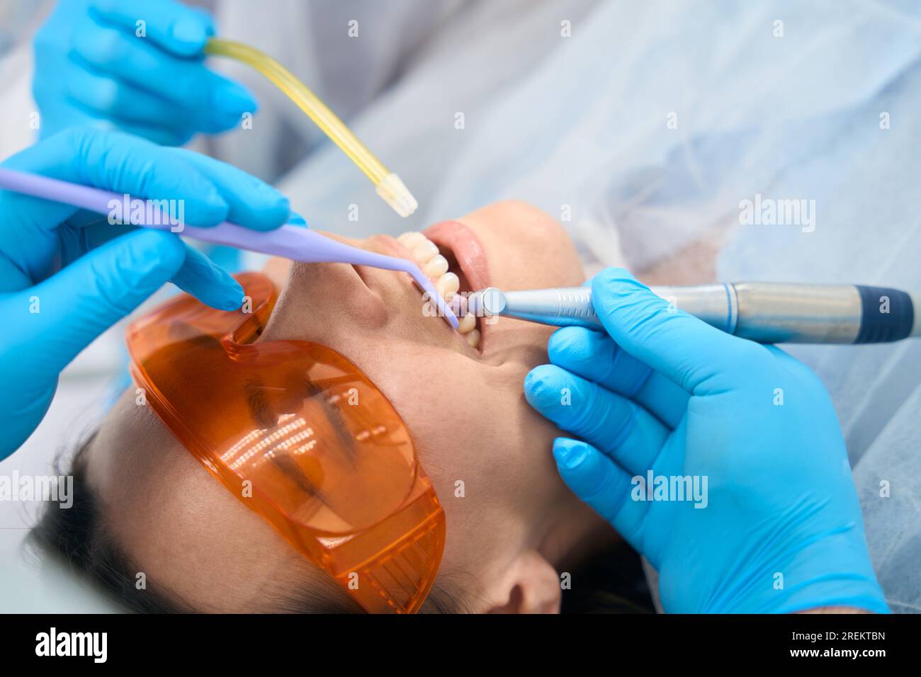 Dentist with the help of assistant works with patients tooth Stock ...