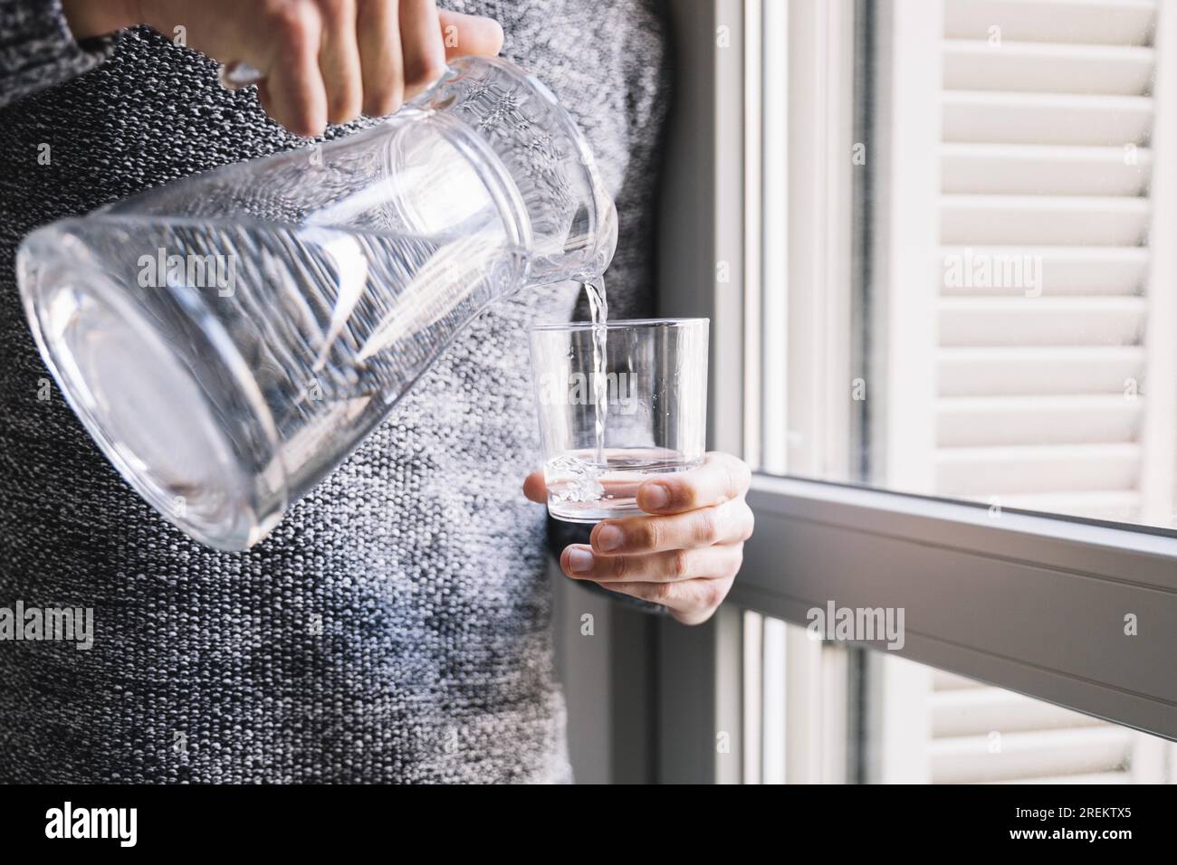 Crop man pouring water near window. Resolution and high quality ...
