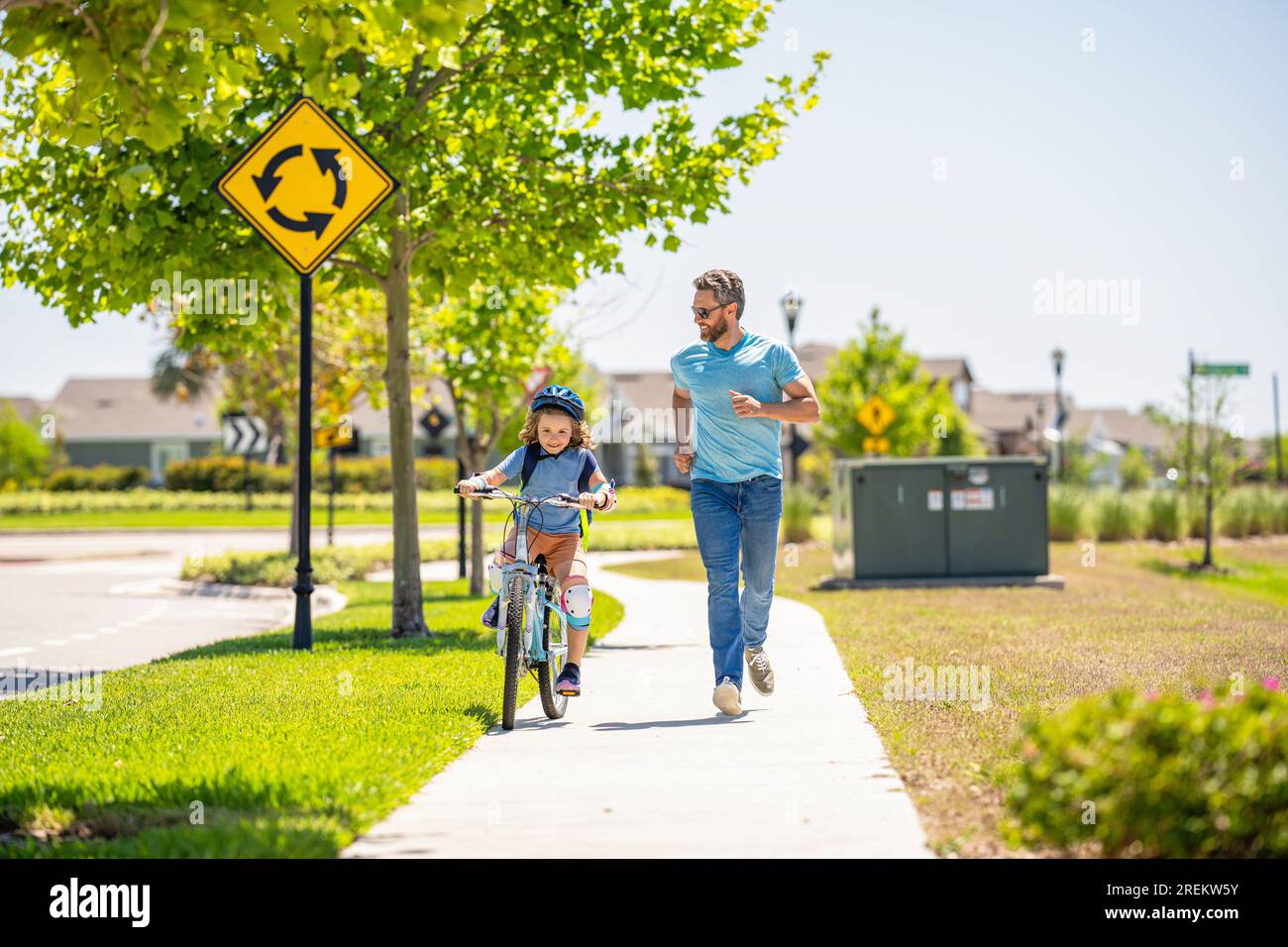 dad and son on biking adventure. dad and son duo pedaling through ...
