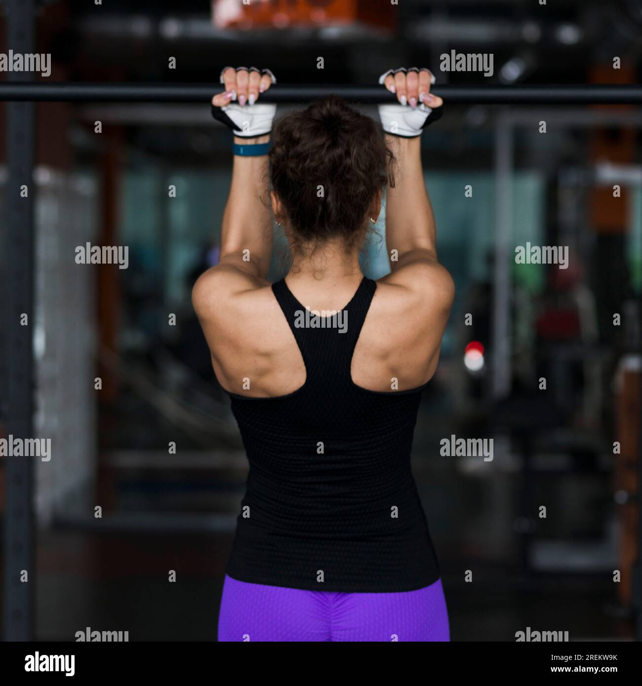 Back view woman performing pull ups. Beautiful photo Stock Photo - Alamy