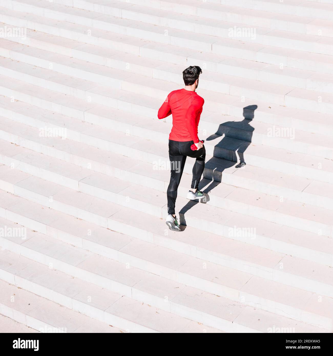 Back view man running upstairs. Beautiful photo Stock Photo - Alamy