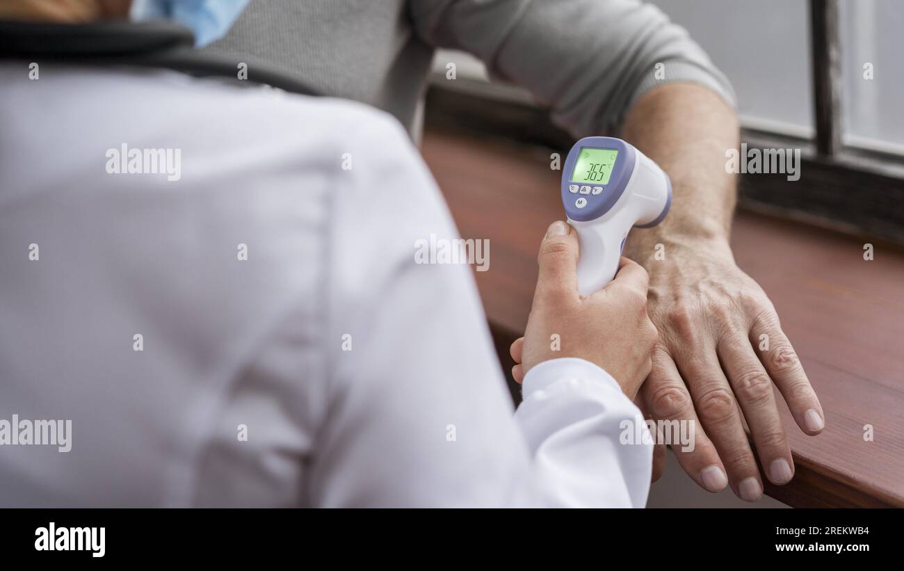 Patient having his temperature checked 2. Resolution and high quality ...