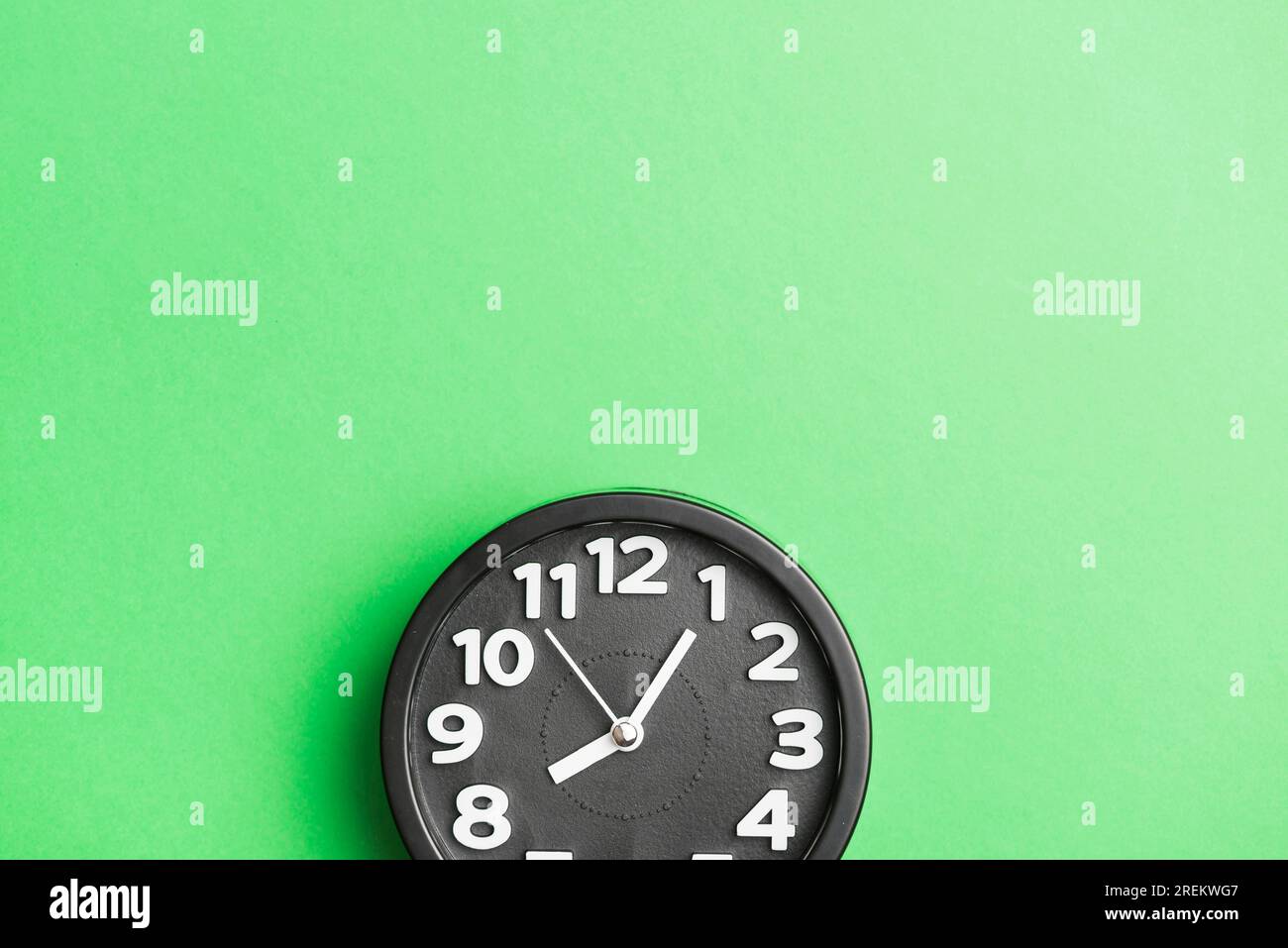 Circular black clock green wall backdrop. Beautiful photo Stock Photo ...