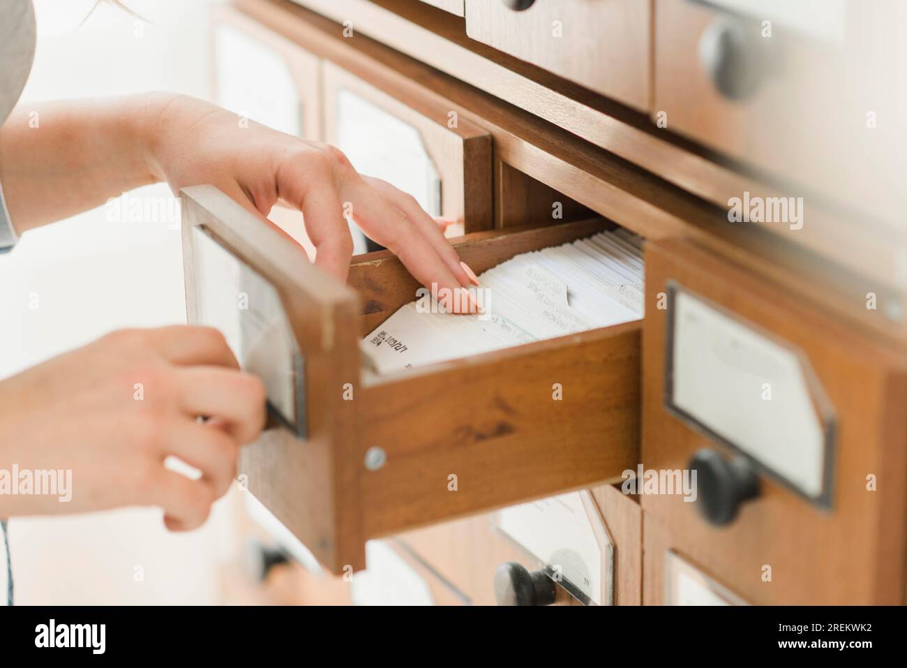 Crop hands searching card drawer. Beautiful photo Stock Photo - Alamy