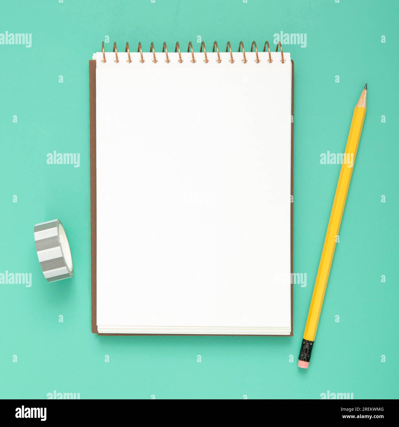 Desk arrangement with empty notepad blue background. Beautiful photo ...