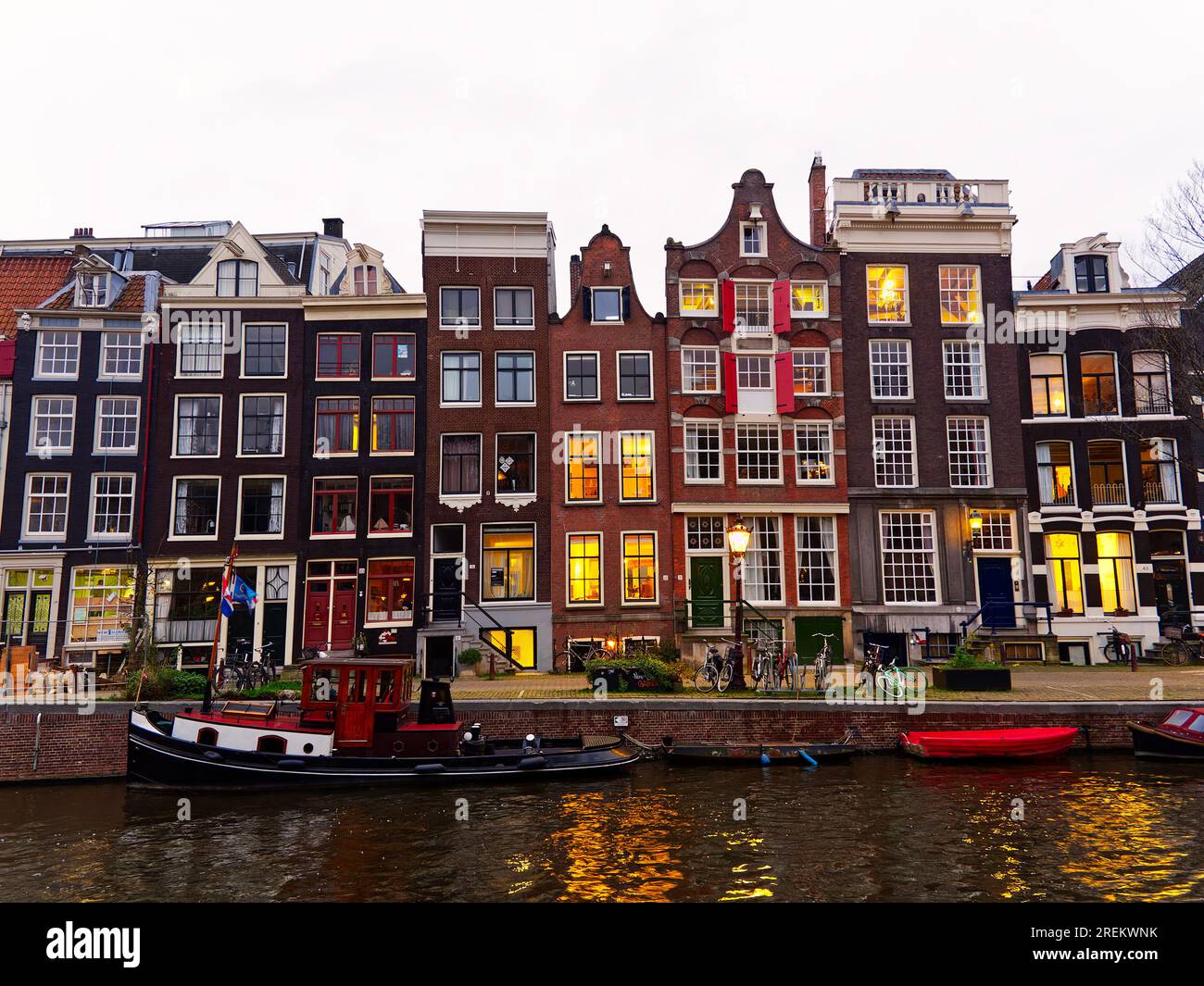 Amsterdam architecture and canals at moody evening in city lights ...