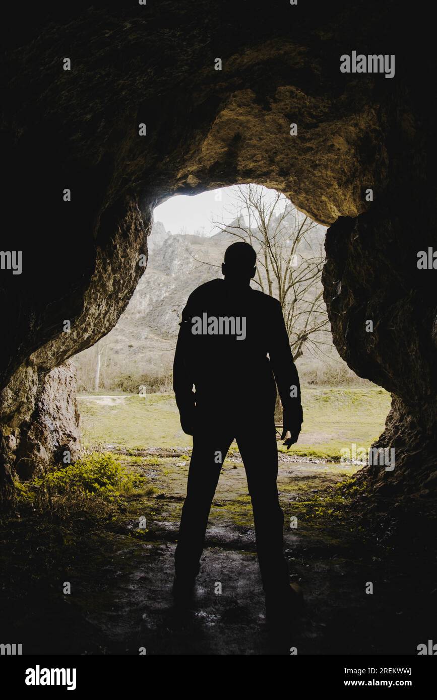 Hiker exploring cave Stock Photo - Alamy