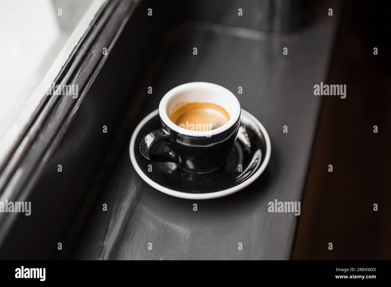 Leftover coffee black cup window sill Stock Photo - Alamy