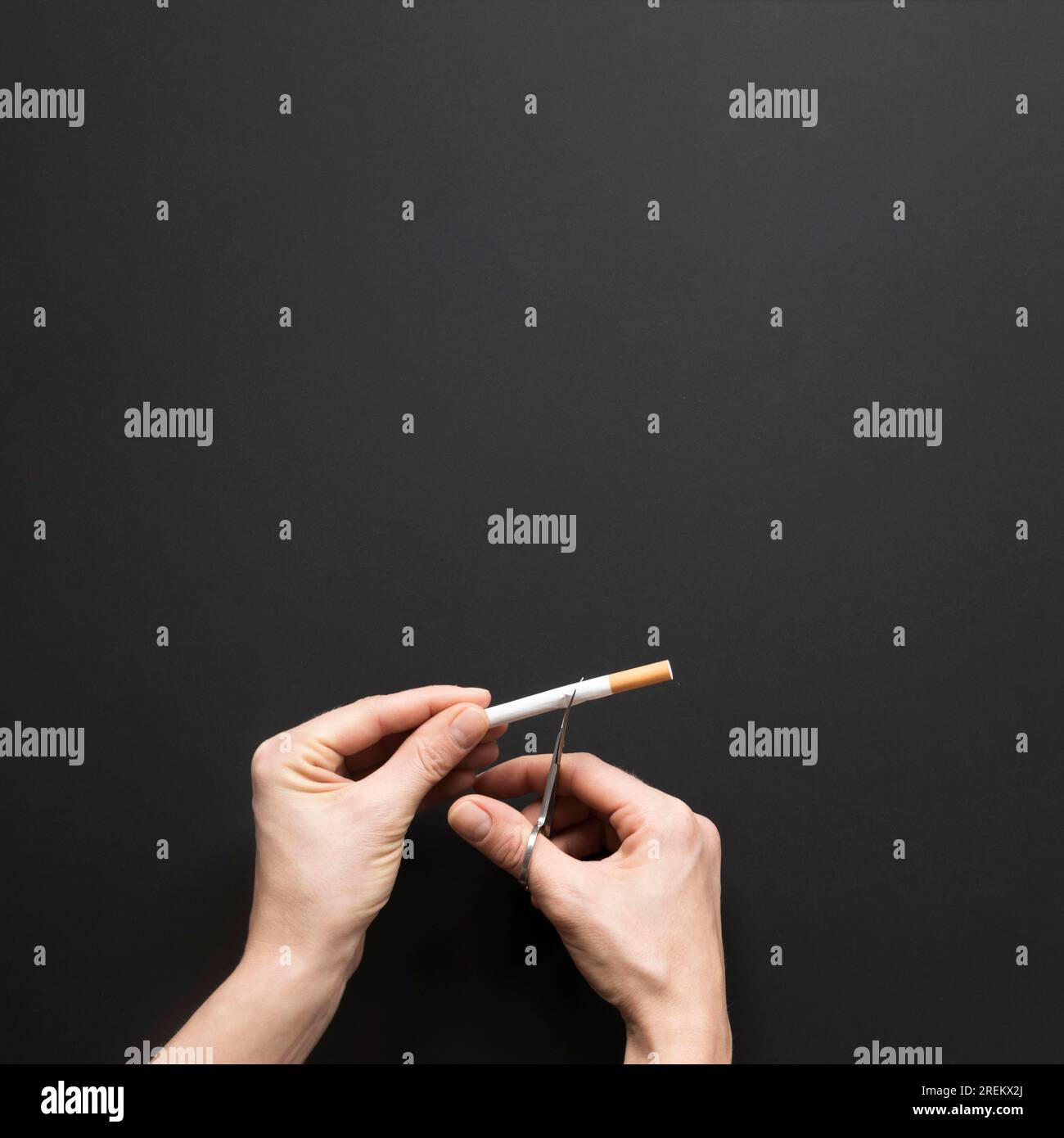 Top view hand cutting cigarette. Beautiful photo Stock Photo - Alamy