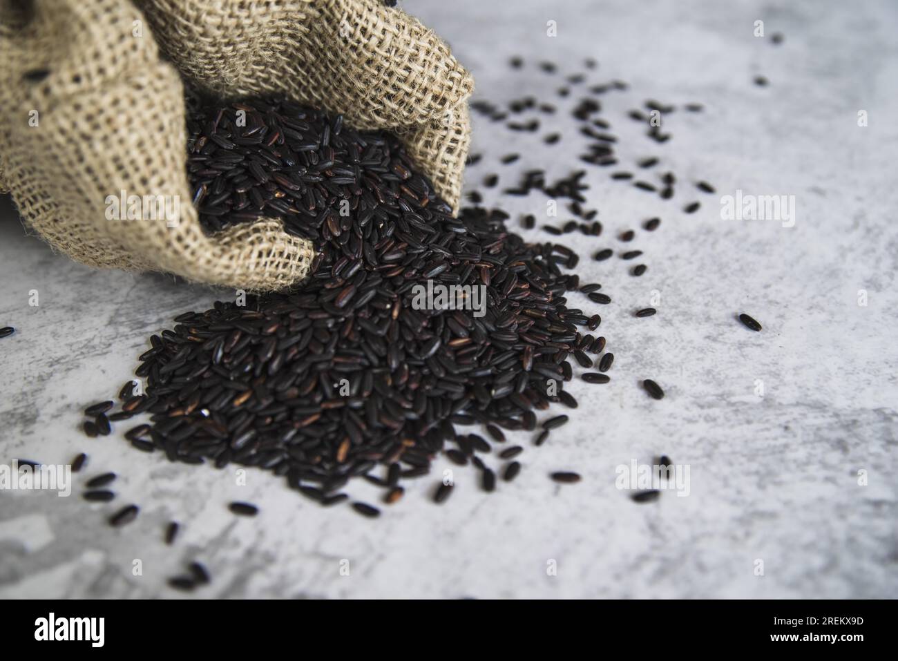 Black rice scattered from sack. High resolution photo Stock Photo - Alamy