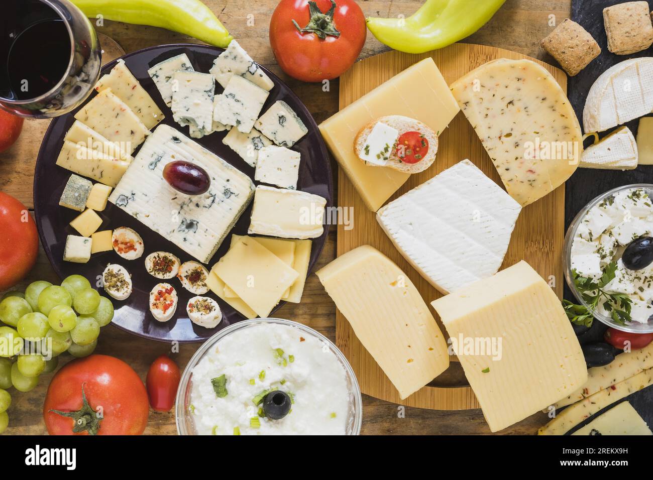 Cheese blocks slices with tomatoes grapes green chili pepper table ...