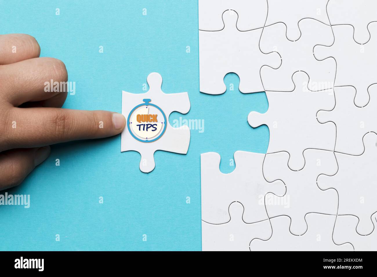 Close up person touching white puzzle with quick tips text stop watch ...
