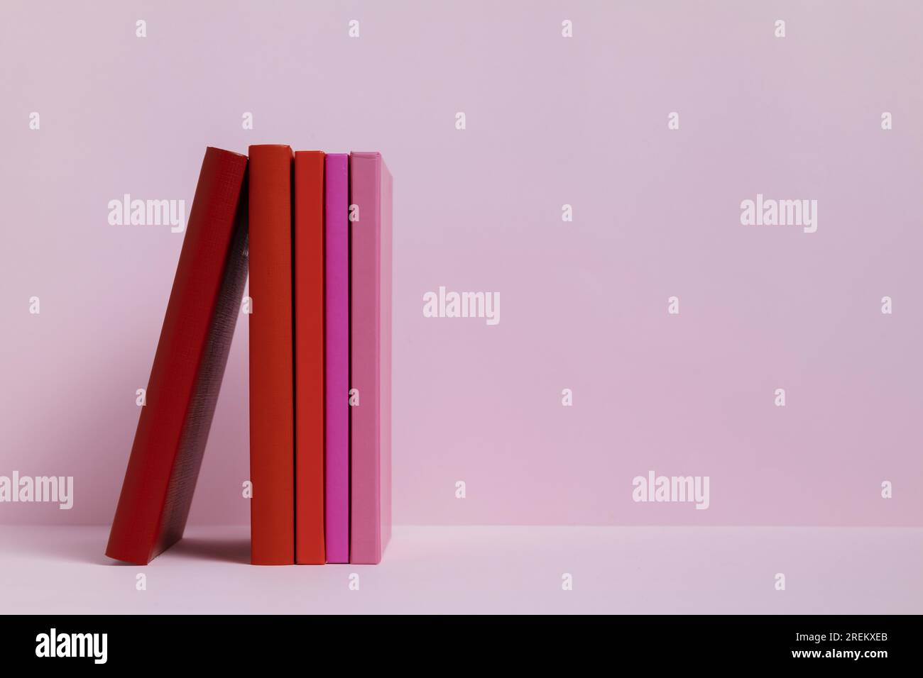 Colorful books with pink background. High resolution photo Stock Photo ...