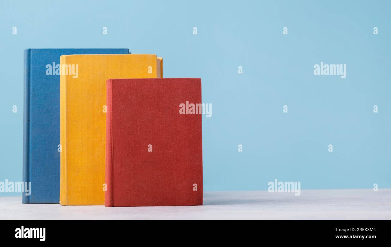 Front view three colored books with copy space. High resolution photo ...