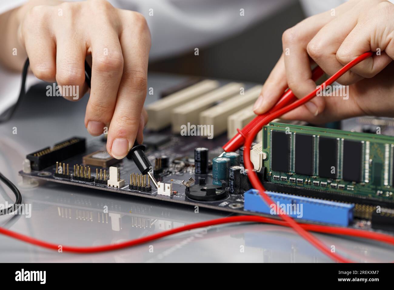 Female technician repairing computer motherboard. High resolution photo ...