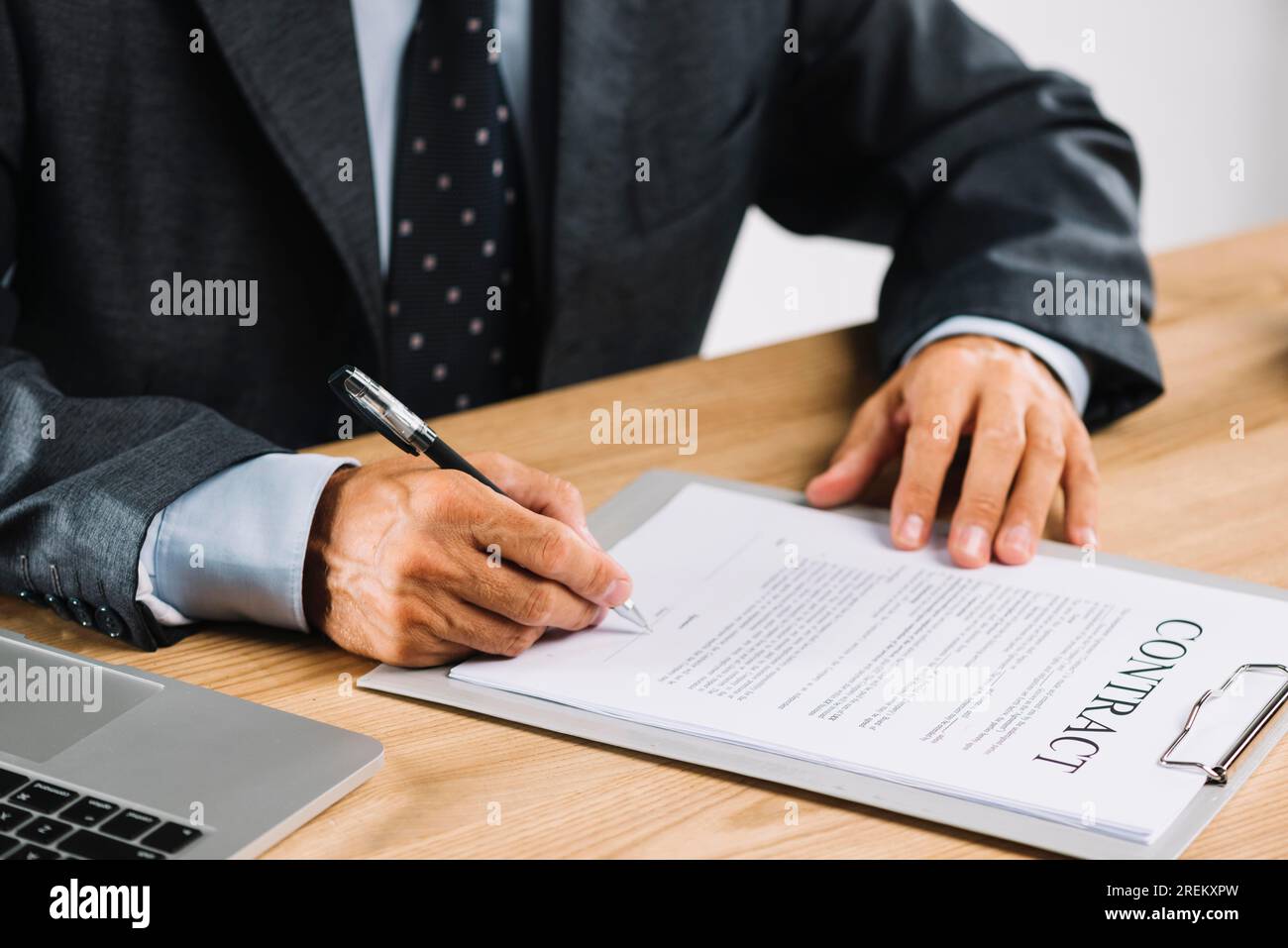 Male lawyer signing contract with pen clipboard. High resolution photo ...