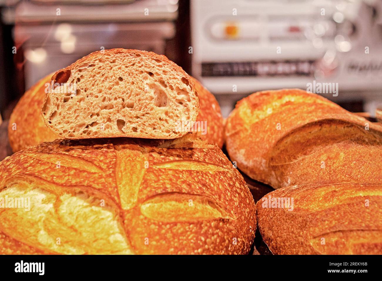 hot baked wheat bread with halves folded in a pile near the oven ...