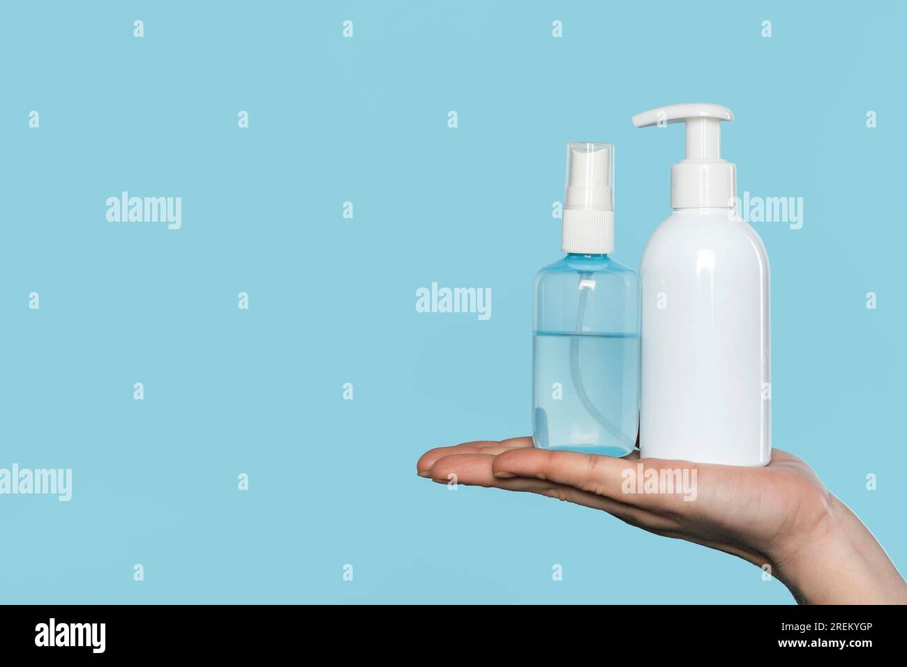 Woman holding disinfectant bottles. High resolution photo Stock Photo ...