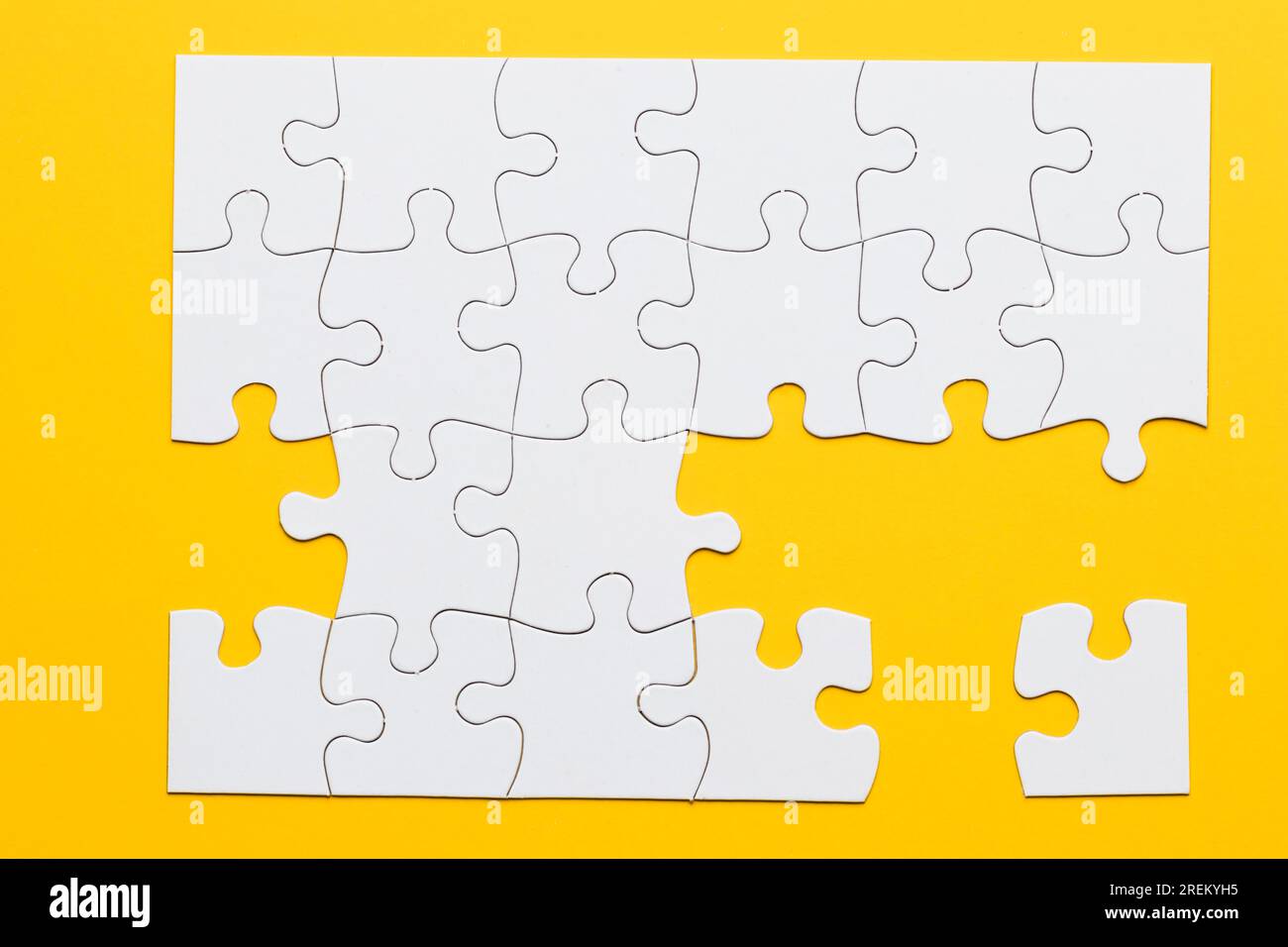 White cardboard jigsaw puzzles yellow background. High resolution photo ...