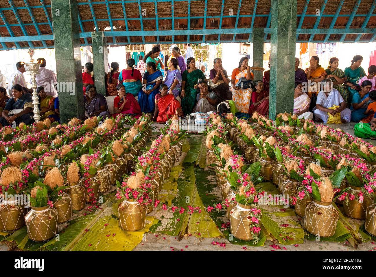 Performing Pooja puja for decorated brass pots during Vinayak Chaturthi ...