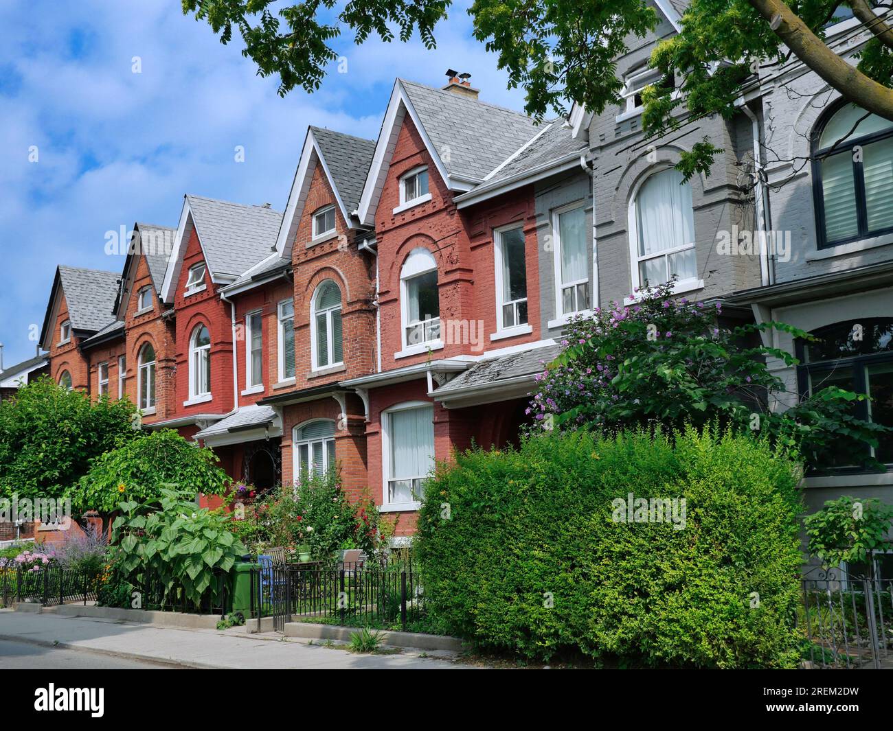 Urban residential street with colorful Victorian row houses with ponty ...