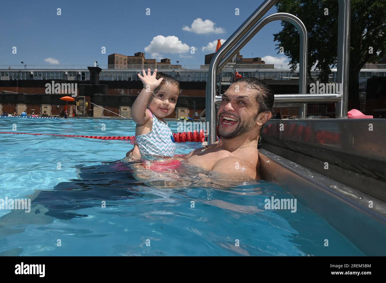 New York, USA. 28th July, 2023. Sandy Zabala, 2, is held by her father ...