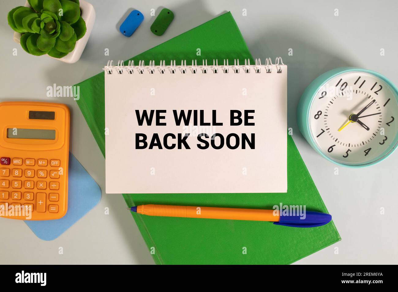 We'll Be Back Soon on sticky note on the notebook on the chart ...