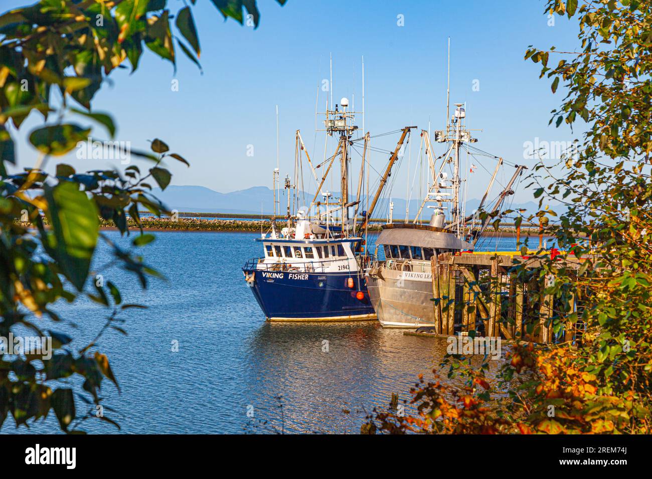 Two commercial fishing vessels moored to a jetty in Steveston British ...