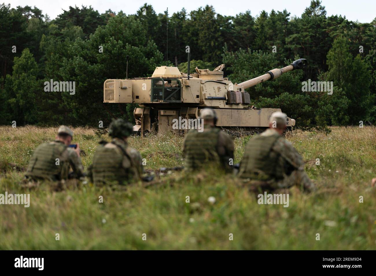 Lithuanian Land Forces soldiers observe An M109A6 Paladin self ...