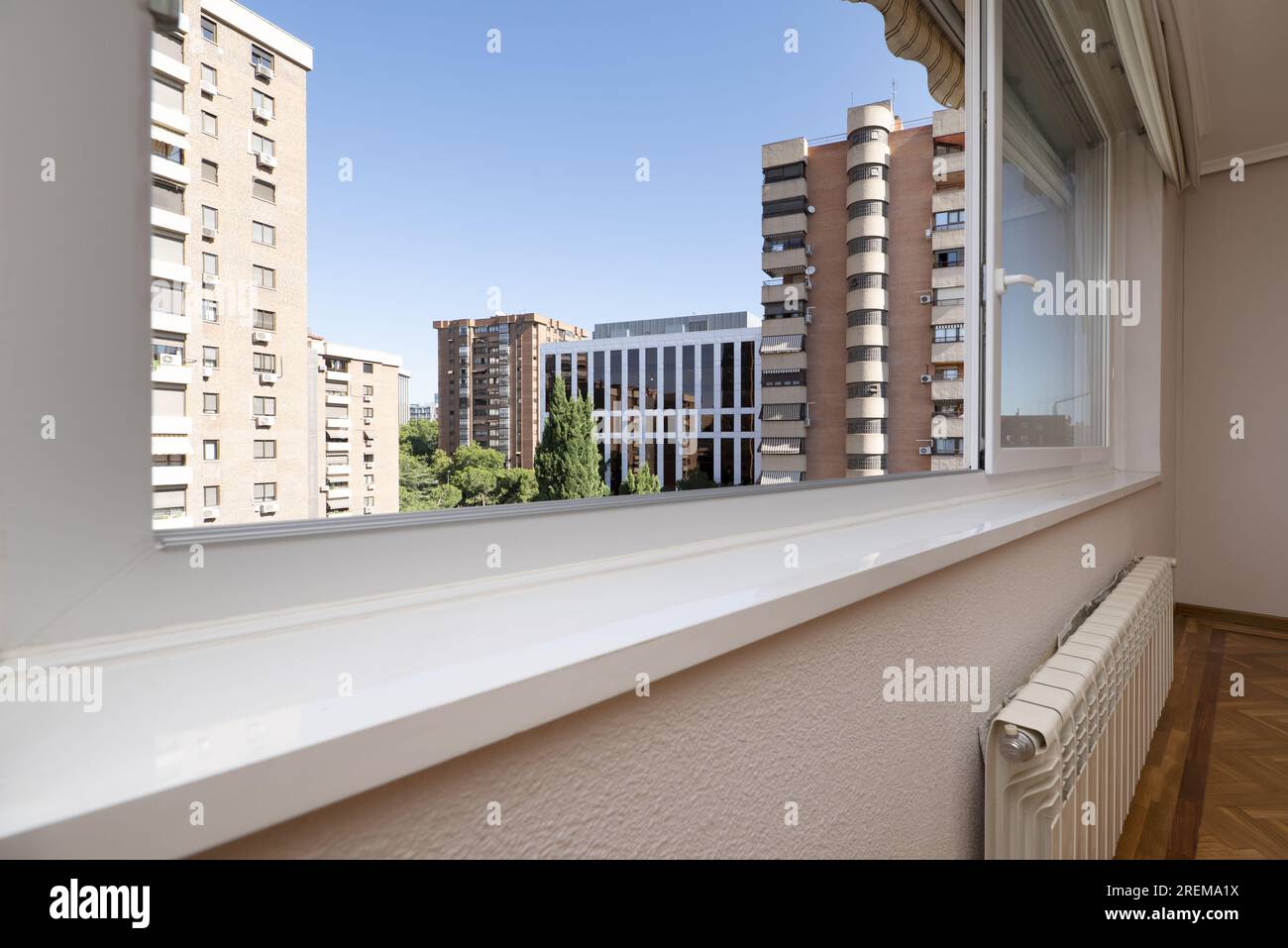 interior sill of a sliding white aluminum window with a view of the ...