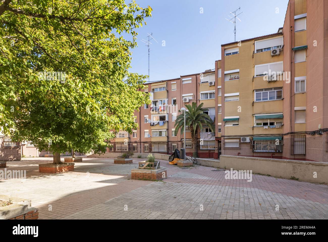 Cobbled promenade of a development with raised tree pits built with ...