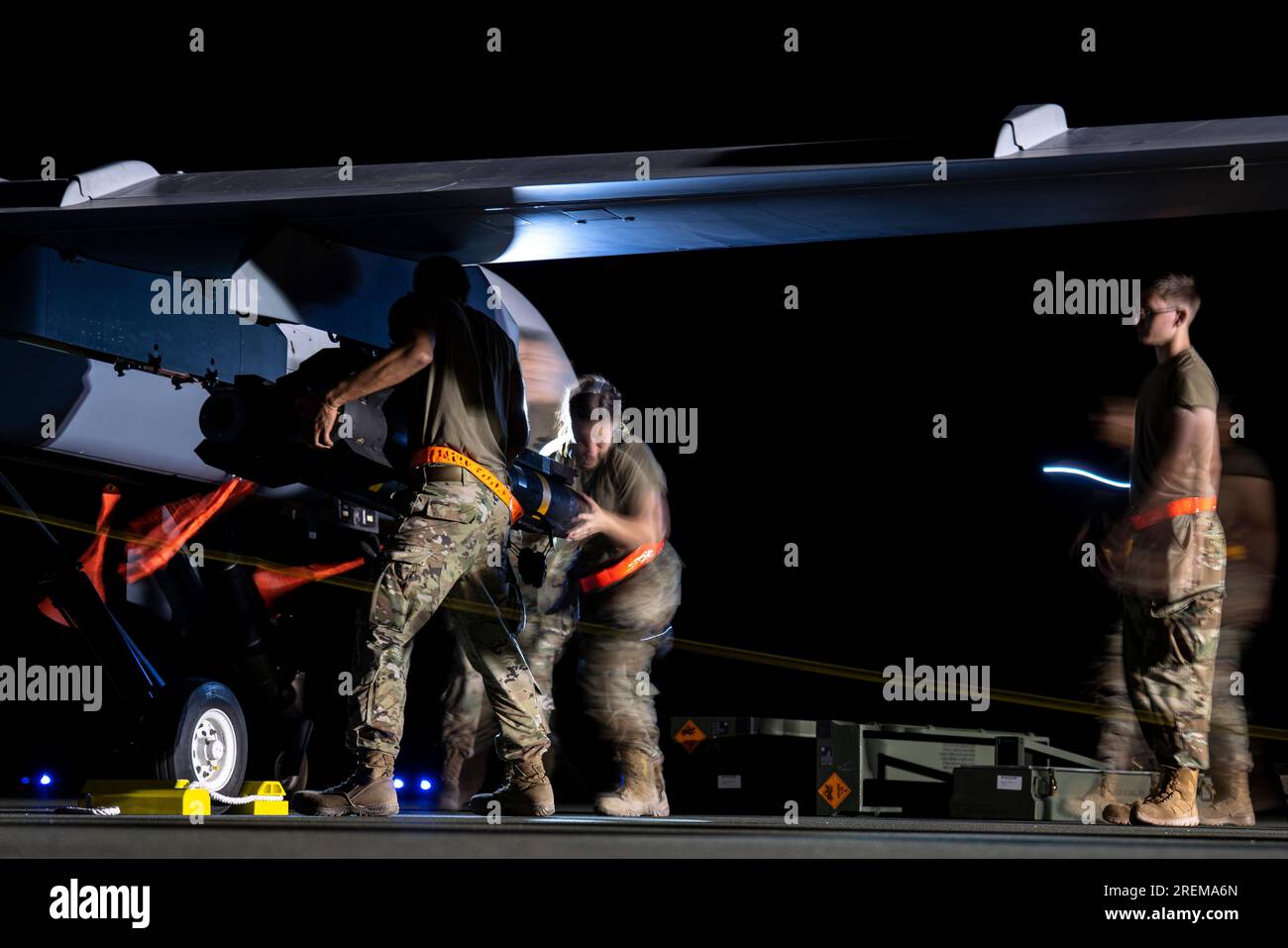 U.S. Air Force Airmen from the 432nd Maintenance Squadron arm an MQ-9 ...