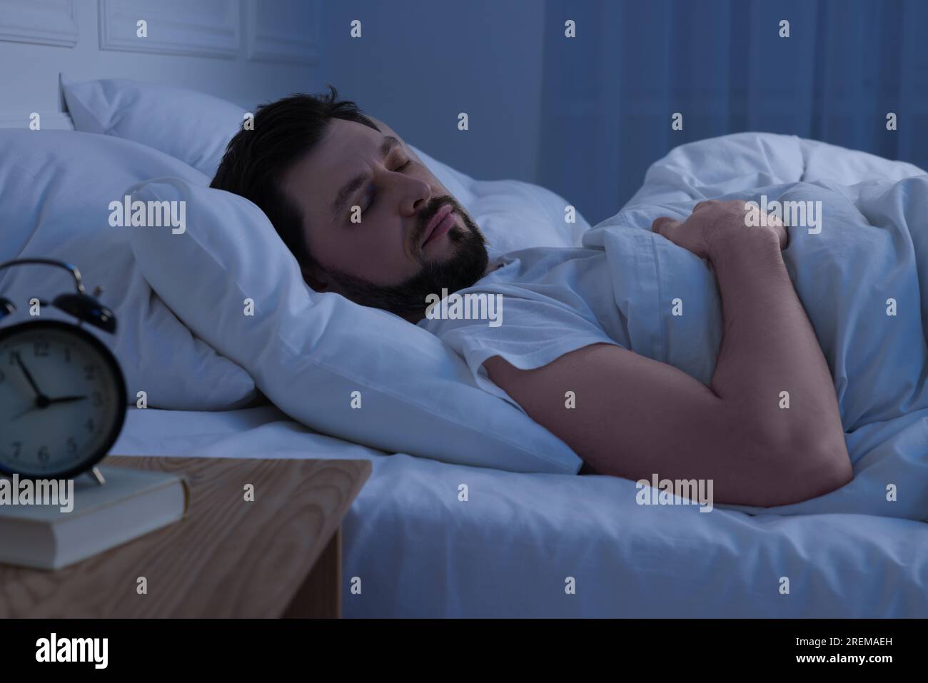 Handsome man sleeping in bed at night Stock Photo - Alamy