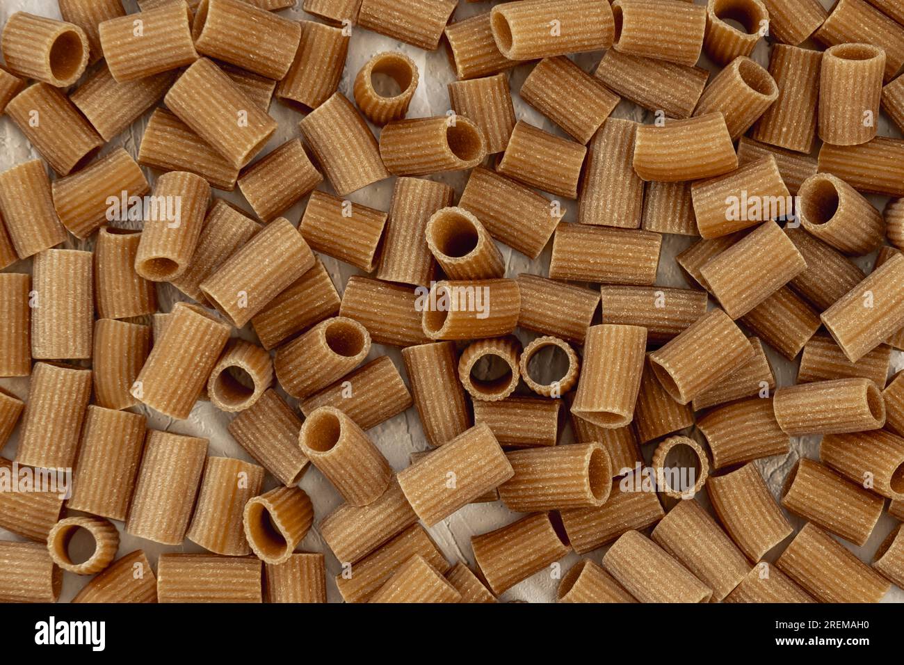 Tubes of cut whole wheat pasta placed in bulk Stock Photo - Alamy