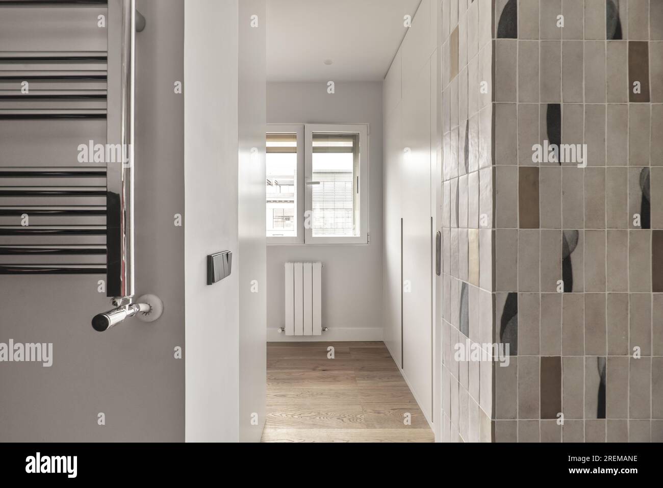 Walls of a tiled bathroom with decorative modern tiles and a chrome ...