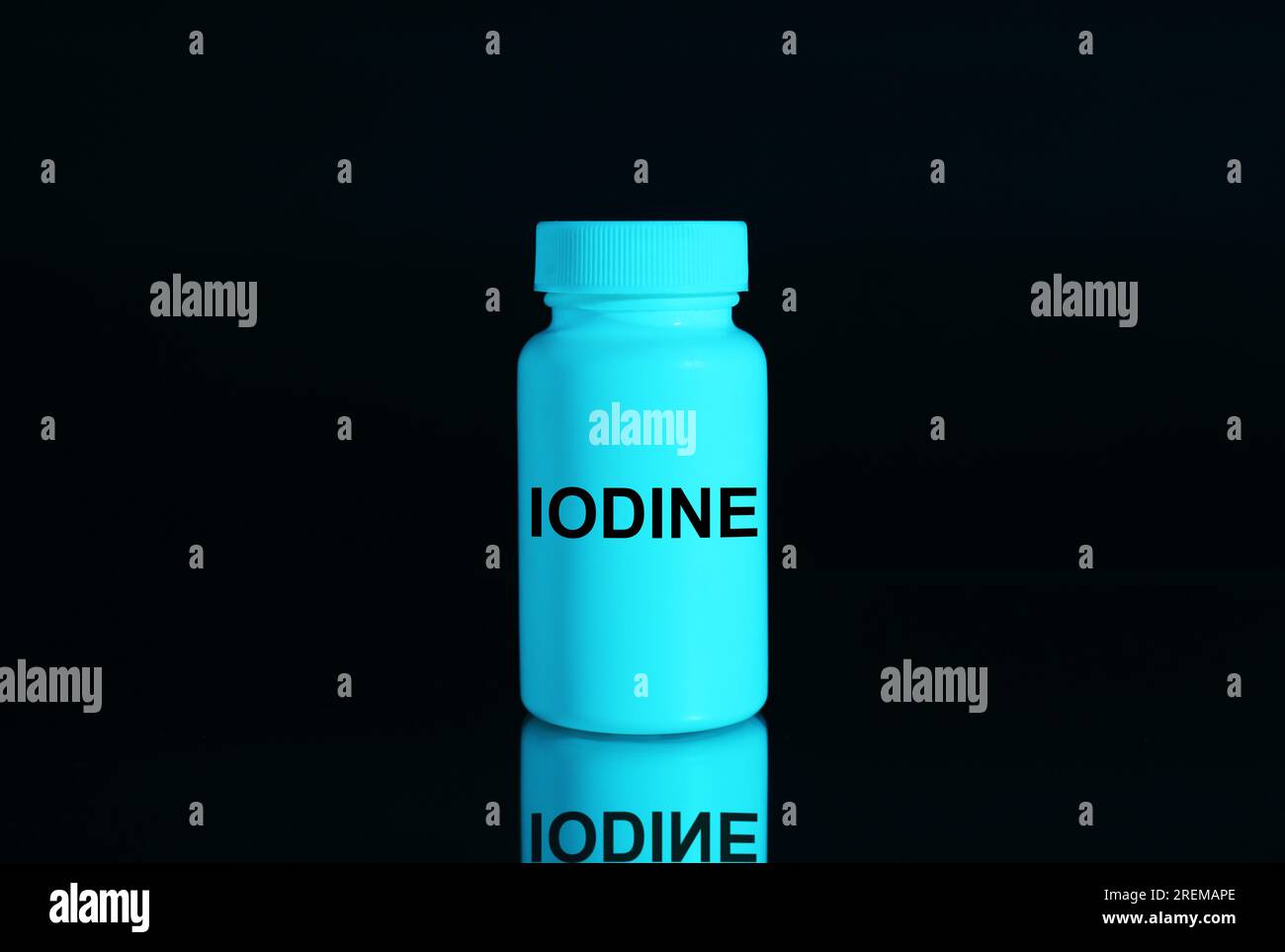 Plastic container of medical iodine on black background, color tone ...