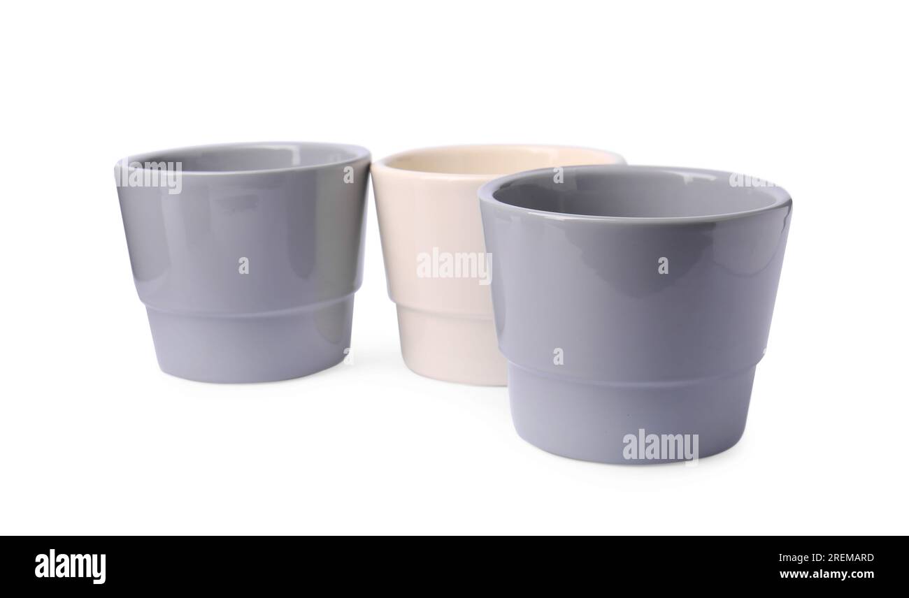 Different empty ceramic flower pots on white background Stock Photo - Alamy