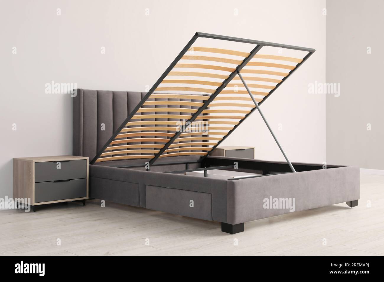 Comfortable bed with storage space for bedding under lifted slatted ...