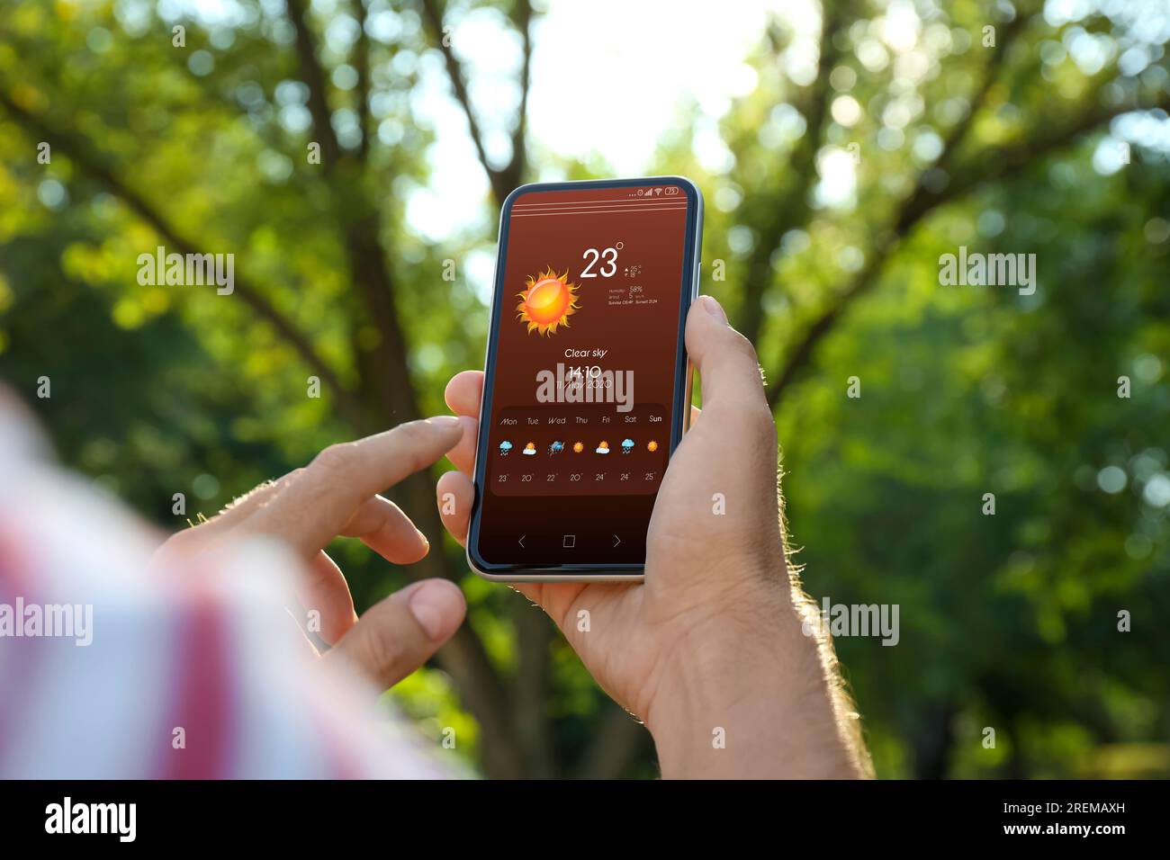 Man checking weather using app on smartphone outdoors, closeup. Data ...