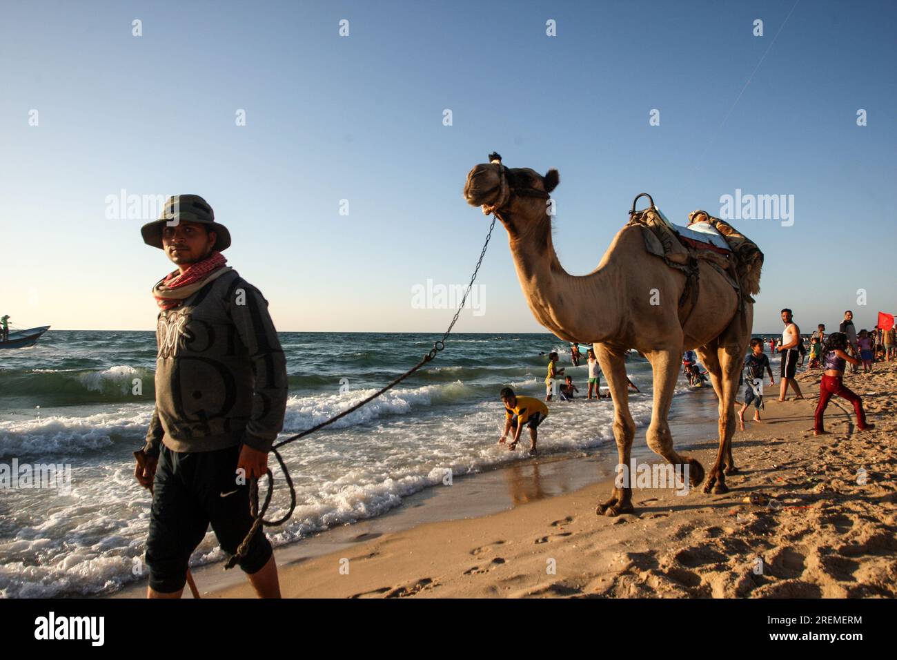 Khan Yunis, Gaza. 28th July, 2023. A Palestinian walks with his camel ...