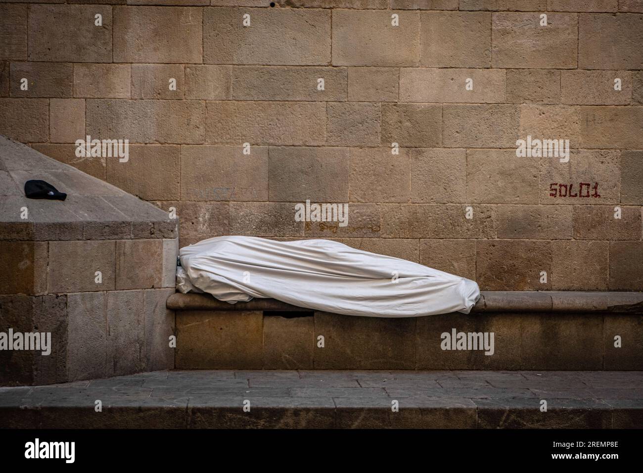 Barcelona, Spain. 28th July, 2023. A homeless is seen sleeping early in ...