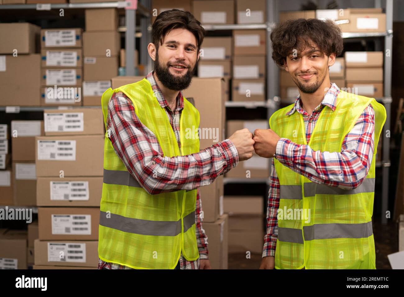 Warehouse workers giving fists to each other. Industrial workers hands ...