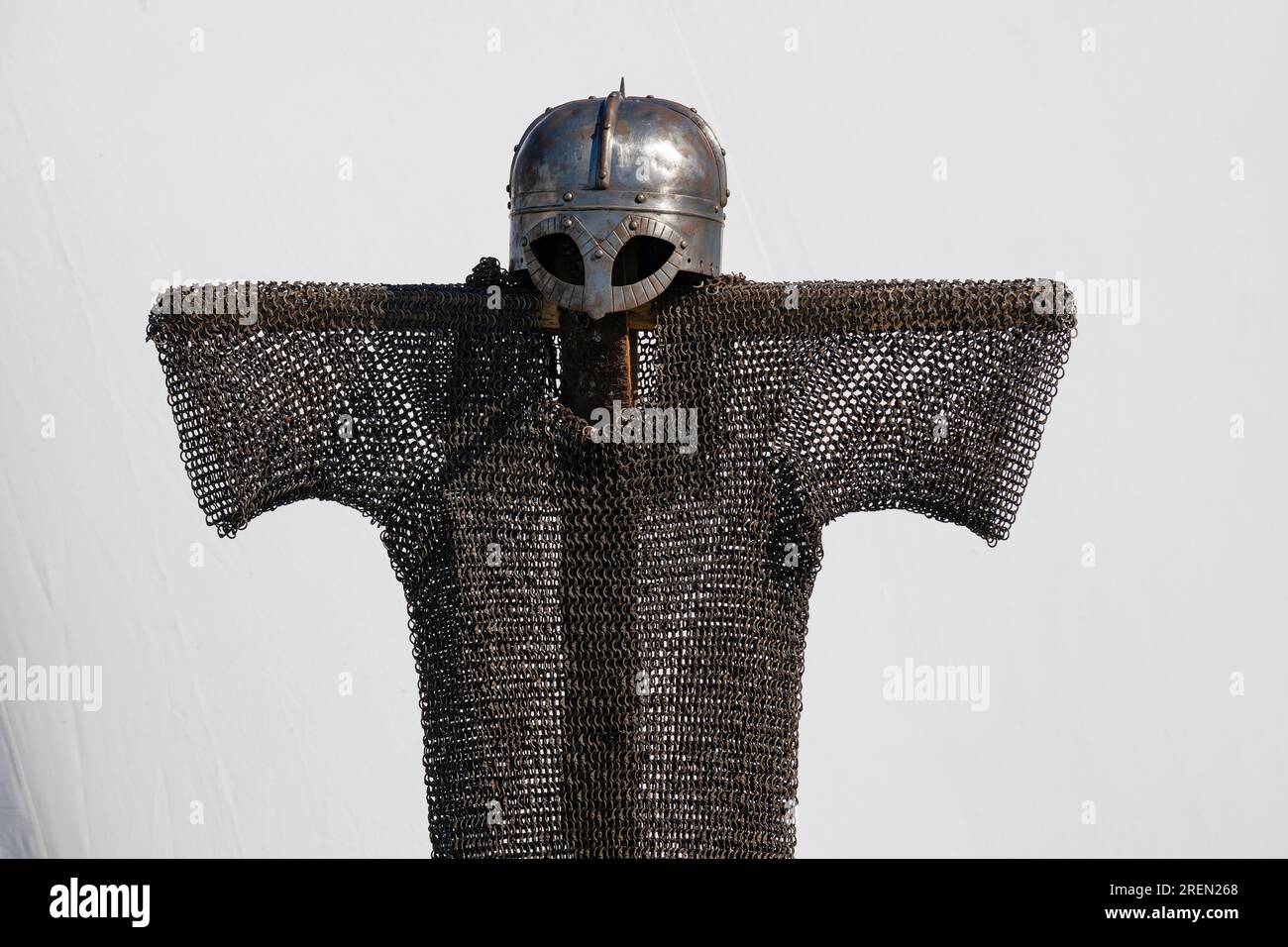Early medieval viking helmet and chain mail on a hanger on a white ...